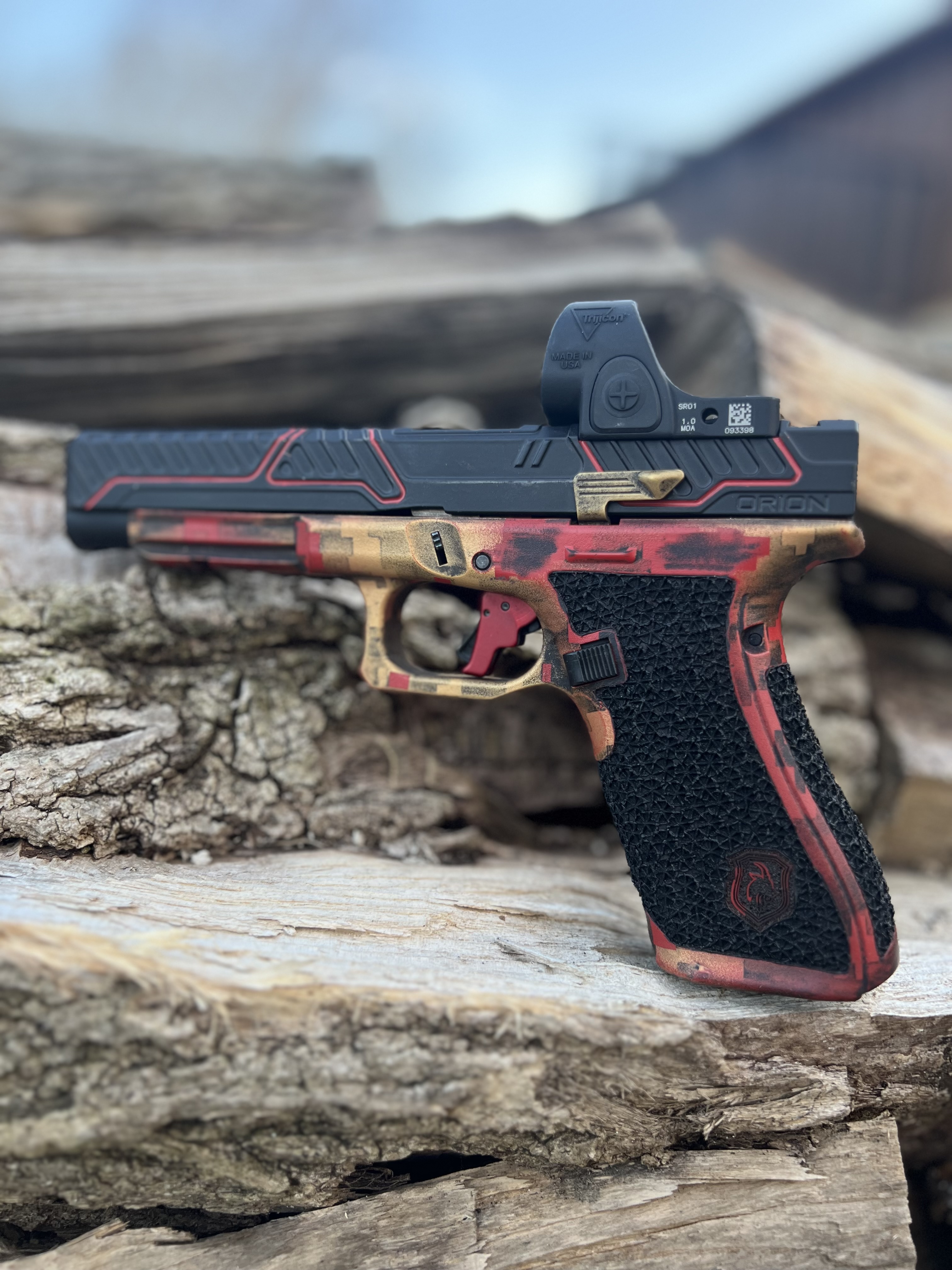 Pistol featuring a Graphite Black, Firehouse Red and Gold Finish | Cerakote